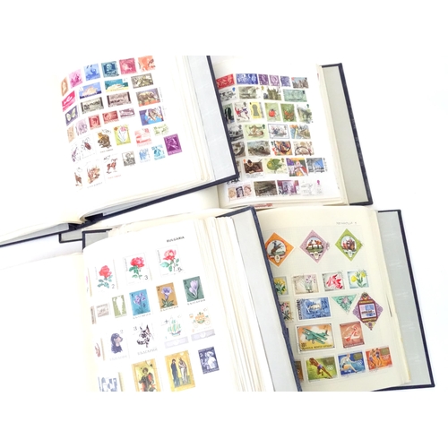 A quantity of 19th and 20thC postage stamps affixed within five albums ...