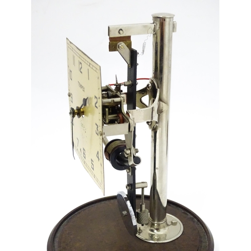 A Tempex electric clock mounted on a Bakelite base with chrome fitting ...