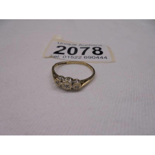 A 9ct gold three stone ring, size M, 1.2 grams.