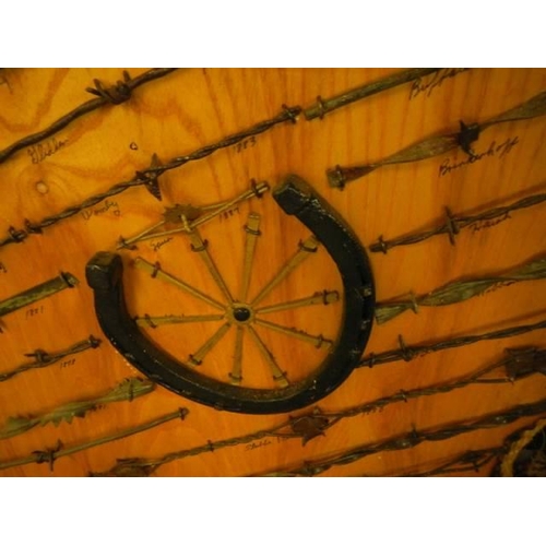 An unusual wall display of rare barbed wire samples, COLLECT ONLY.