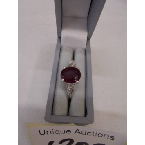 A single stone ruby ring set with diamond shoulders in 18ct white gold, size N, 3.47 grams.