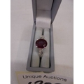 A single stone ruby ring set with diamond shoulders in 18ct white gold ...