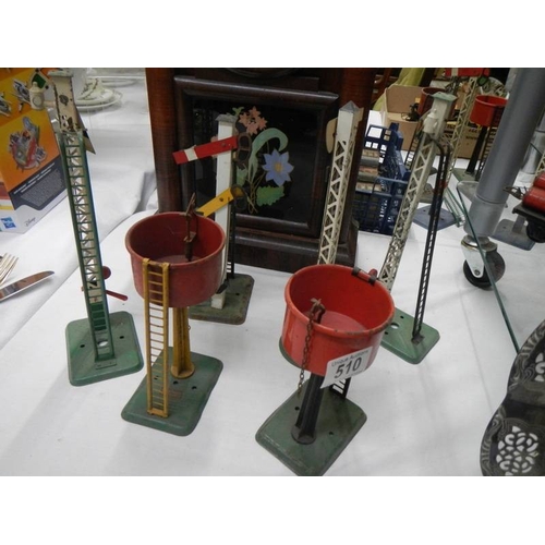 Four Hornby 'O' gauge railway signals and two water towers.