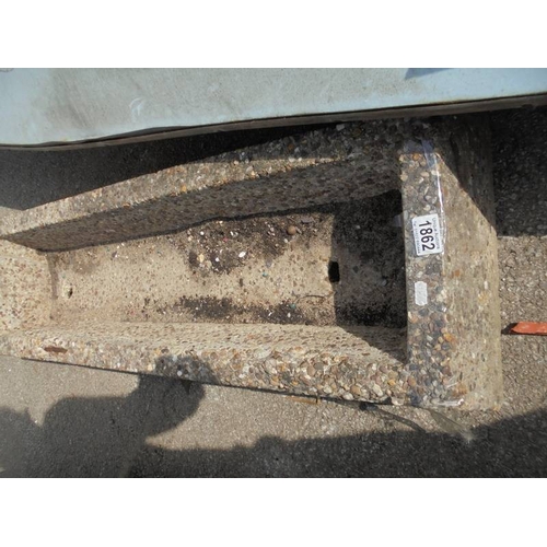 A rectangular stone trough.