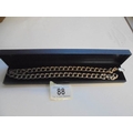 A heavy silver neck chain, 61 grams.