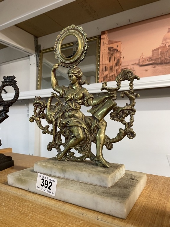 An English brass pocket watc stand in the form of a lady