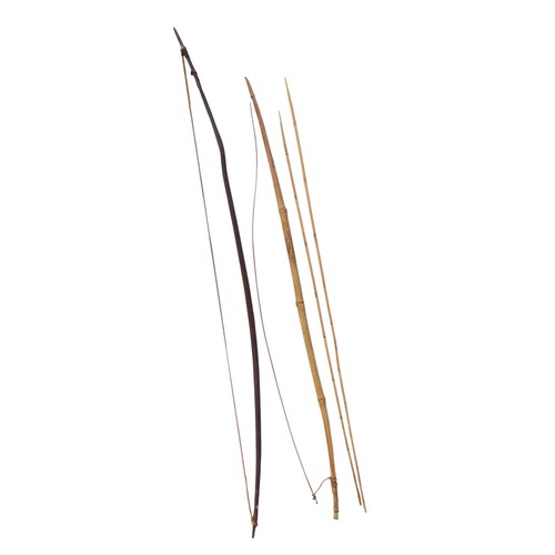 A DANI BOW, WOOD WITH ORCHID FIBRE AND REED and a bamboo bow with two ...