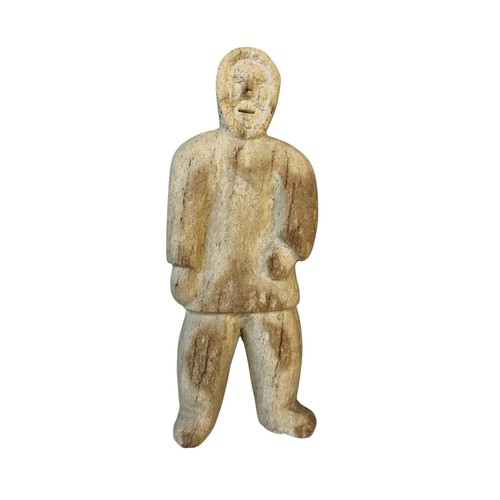 AN INUIT PETRIFIED WHALEBONE FIGURE DEPICTING A STANDING MALE, Clyde ...