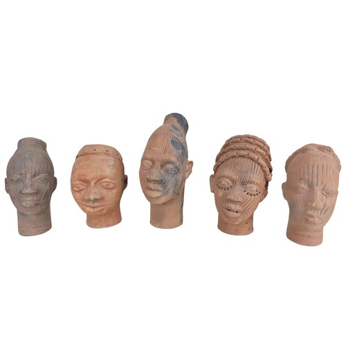 AN IFE TERRACOTTA HEAD with scarified facial features and ornate hair ...