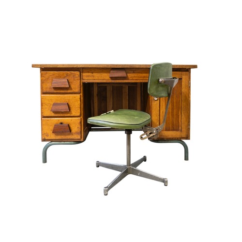 AN OAK MID-CENTURY MINISTRY STYLE DESKrectangular top above a bank of ...
