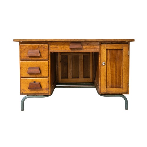 AN OAK MID-CENTURY MINISTRY STYLE DESKrectangular top above a bank of ...
