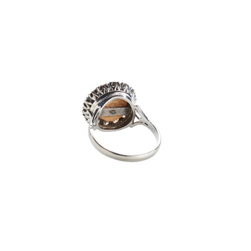 A MABE PEARL AND DIAMOND RING,the mabe pearl within a surround of ...