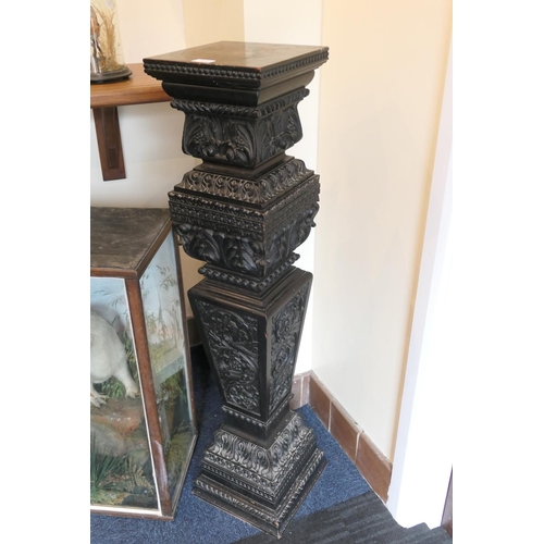 Continental carved ebonised torchere, height 114cm, the top 24.5cm square