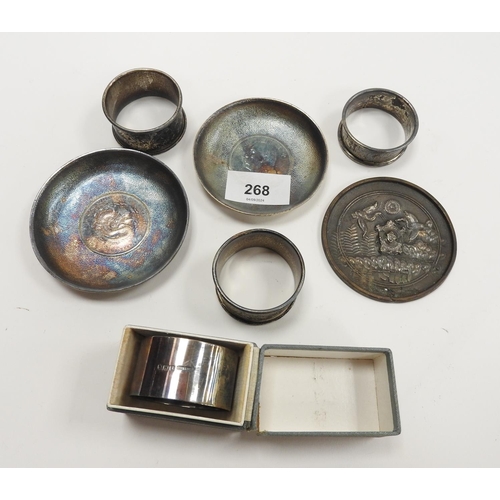Two Chinese white metal coin coasters, also four silver napkin rings ...