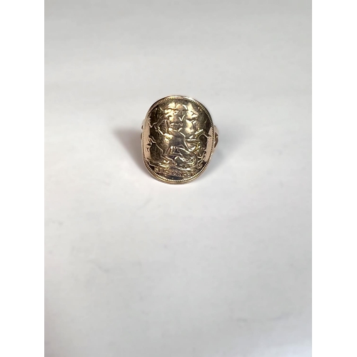 A 9ct gold signet ring with Sovereign like coin frontage 3.9gms
