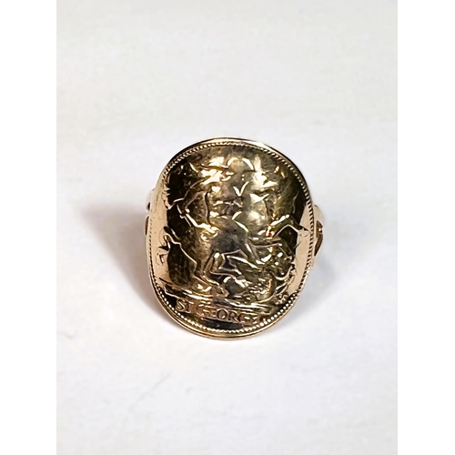 A 9ct gold signet ring with Sovereign like coin frontage 3.9gms