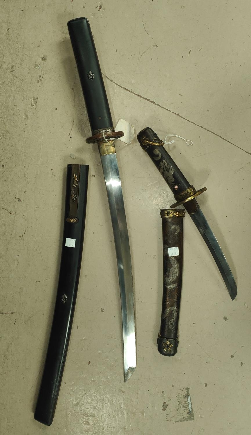 Two 20th century Japanese short swords, one blade 42cm with patination ...