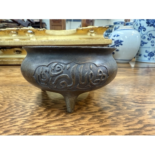A Chinese bronze three footed censor with seal mark to the base ...