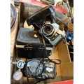 A Cannon SLR camera with spare lens; a gauge; a compressor etc.