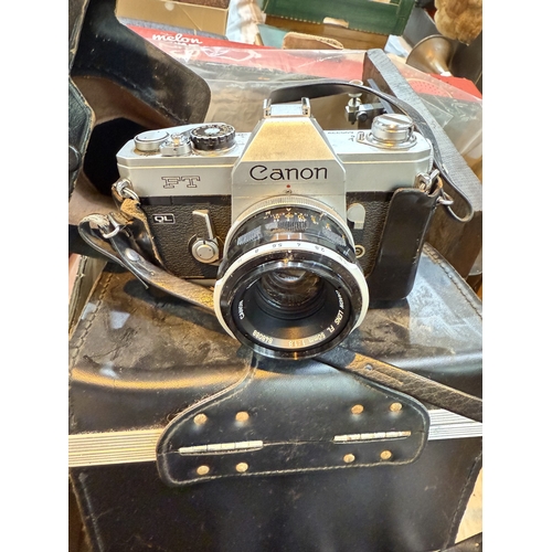 A Cannon SLR camera with spare lens; a gauge; a compressor etc.