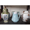 Two lidded porcelain vases together with a mid 20thC blue ceramic jug (3)