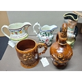 Two early Victorian Staffordshire relief moulded jugs together with a ...