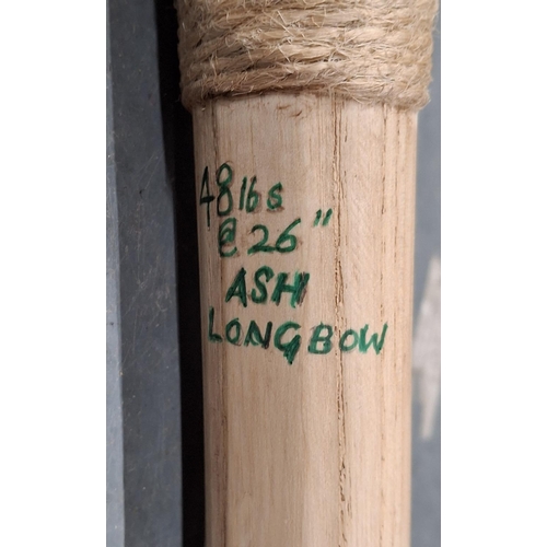 An Ash bow, arrows and a quiver together with a box full of archery books