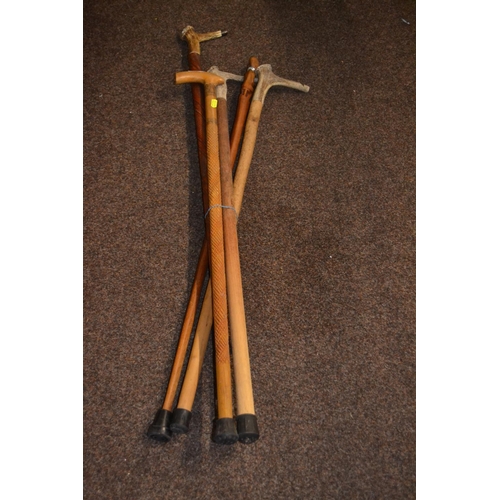 Three antler handled walking sticks, including an antler whistle stick ...