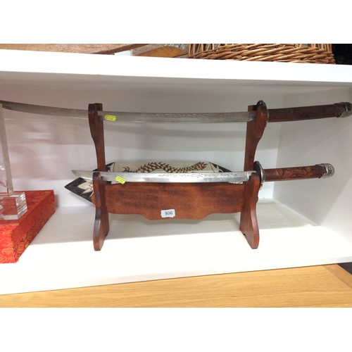 2 Indian ceremonial swords with leather handles on a purpose built ...