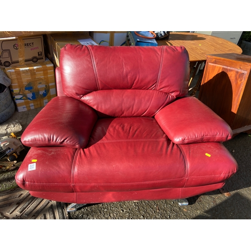 Large Red leather cuddle chair with chrome feet.