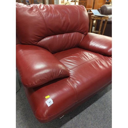 Large Red leather cuddle chair with chrome feet.