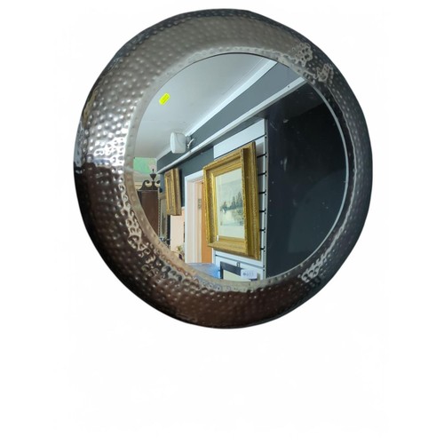 Circular mirror with hammered metal surround. Dia 76cm.