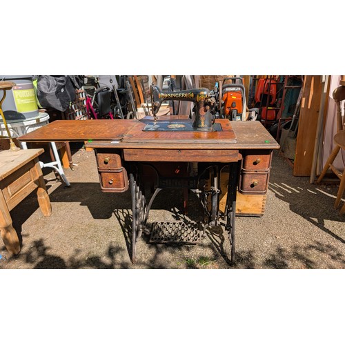 Singer electric sewing machine in treadle table. Table has 5 drawers.