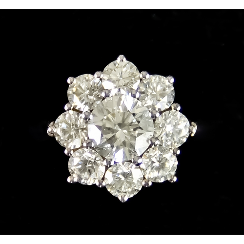 An 18ct White Gold Diamond Flower Head Ring, by Charles Greig, set with ...
