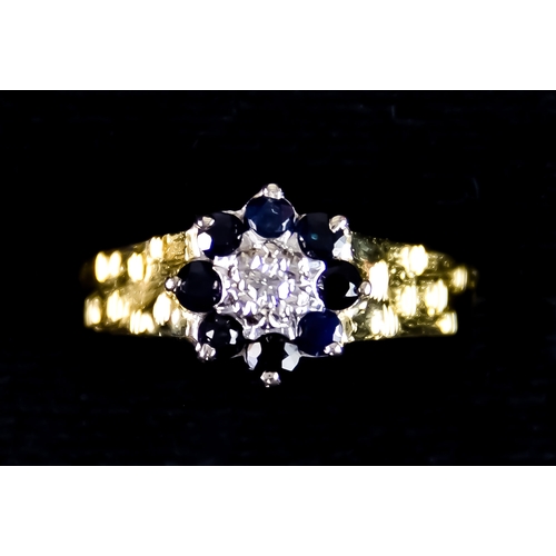 An 18ct Gold Sapphire and Diamond Flower Head Ring, set with a small ...