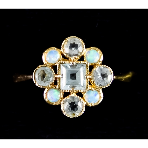 A 9ct Gold Blue Topaz and Opal Flower Head Ring, set with a centre blue ...