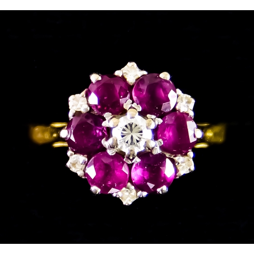 An 18ct Gold Ruby and Diamond Flower Head Ring, set with faceted ruby ...