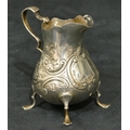 A Victorian silver round bulbous shaped cream jug with crinkled rim ...