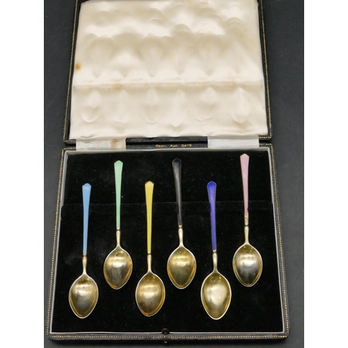 A set of 6 silver gilt and coloured enamelled teaspoons in fitted black ...