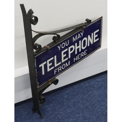 A vintage double-sided enamel sign "You May Telephone From Here ...