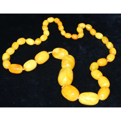 A large Amber graduated bead necklace, 79cm long, 96 grams, largest ...