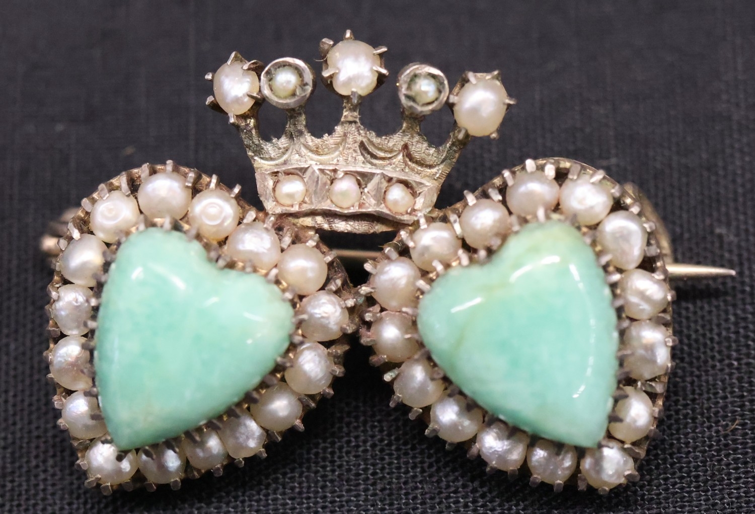 A 19th Century double heart shaped brooch mounted with a crown, inset ...