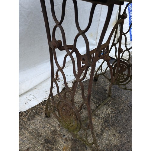 a vintage singer table base with a stone slab top