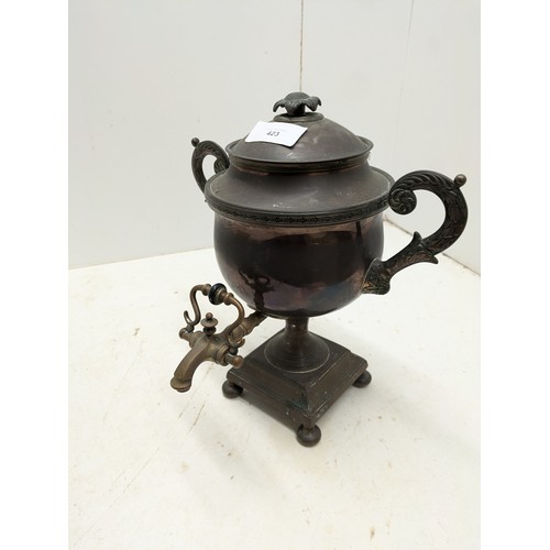 an antique copper tea urn