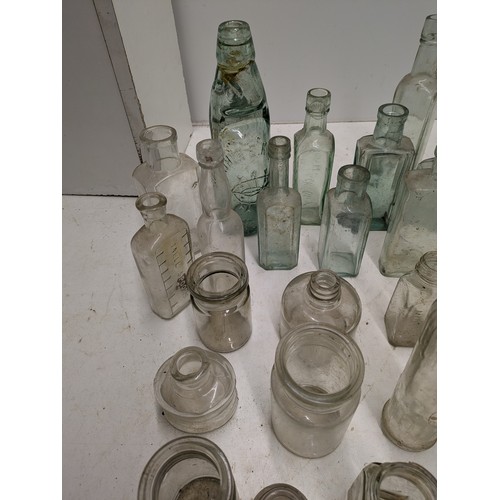 a selection of antique glass bottles including codd bottle