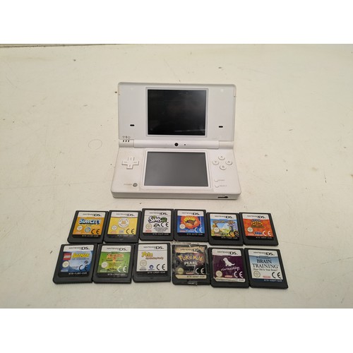 A Nintendo Dsi Console And A Selection Of Games