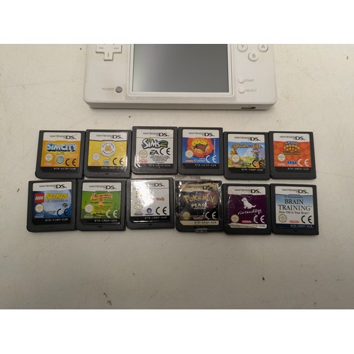 A Nintendo Dsi Console And A Selection Of Games