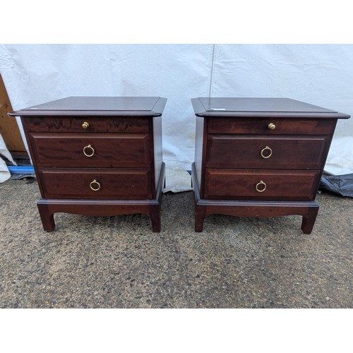 A pair of Stag Minstrel 2 drawer bedside table with pullout extensions