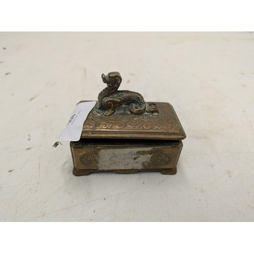 An interesting oriental themed brass trinket box with a Chinese dragon atop
