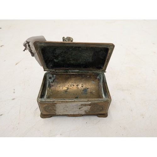 An interesting oriental themed brass trinket box with a Chinese dragon atop